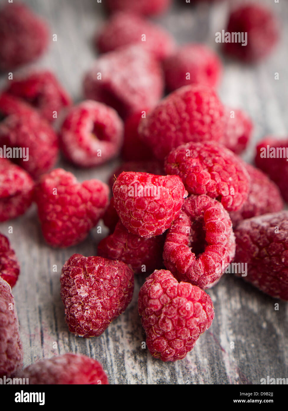 Frozen raspberries on a table Stock Photo - Alamy