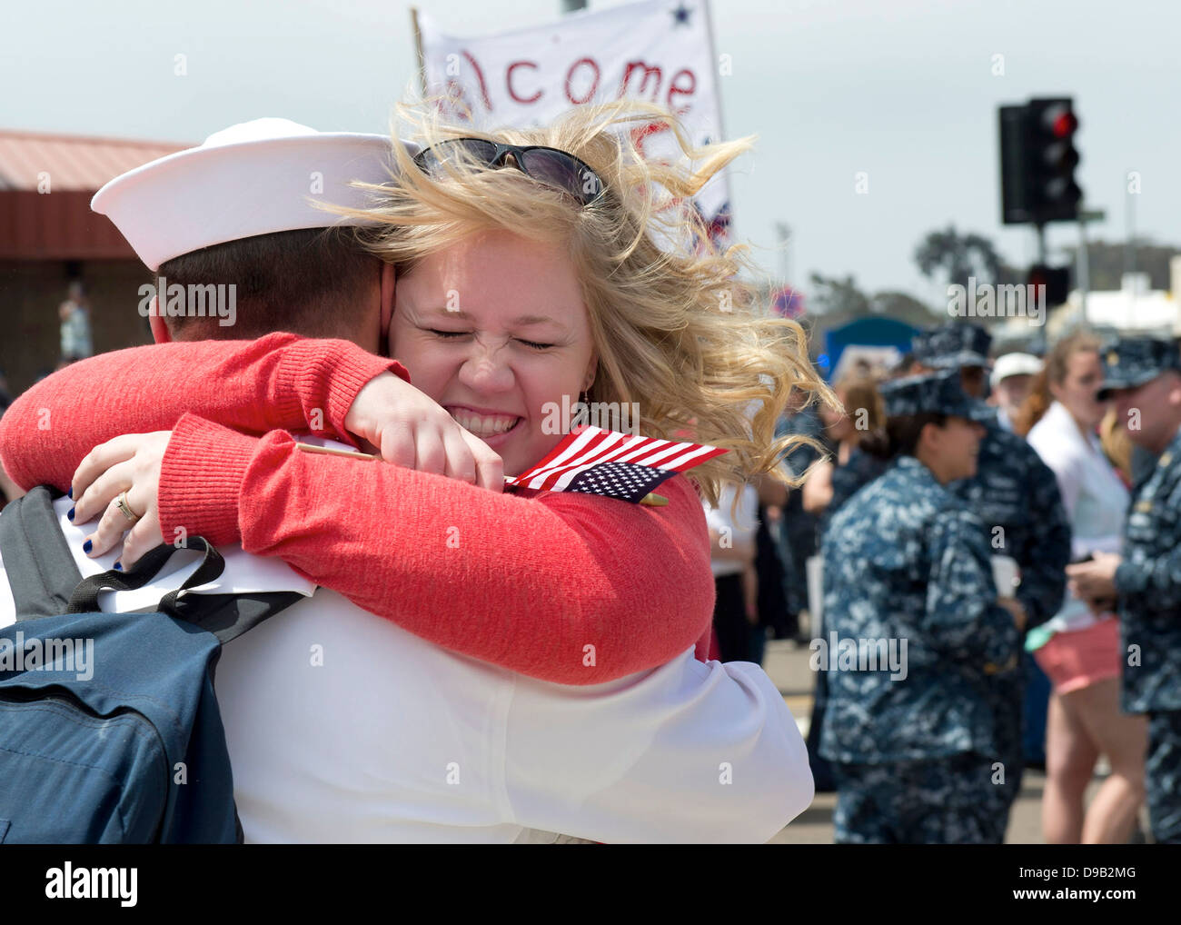 A US Navy sailor hugs his wife after returning home from deployment ...