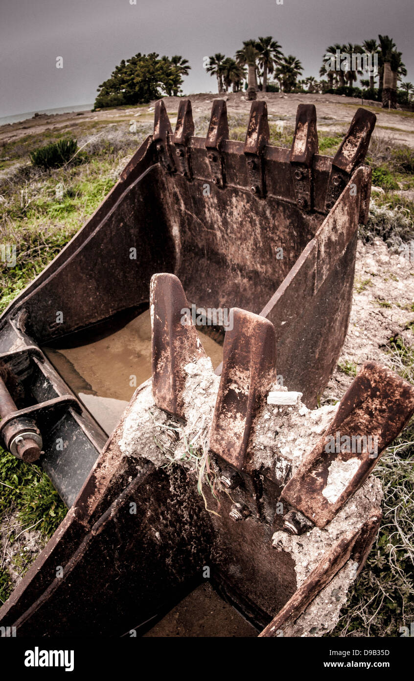 Rusty digger bucket on beach at abandoned construction project, Cyprus ...