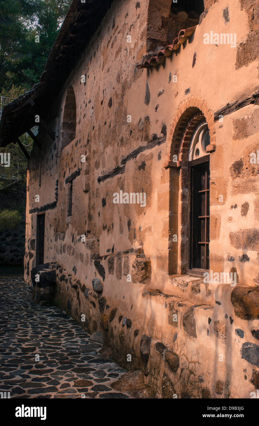 Traditional stone built Cypriot building, situated along a cobbled road ...