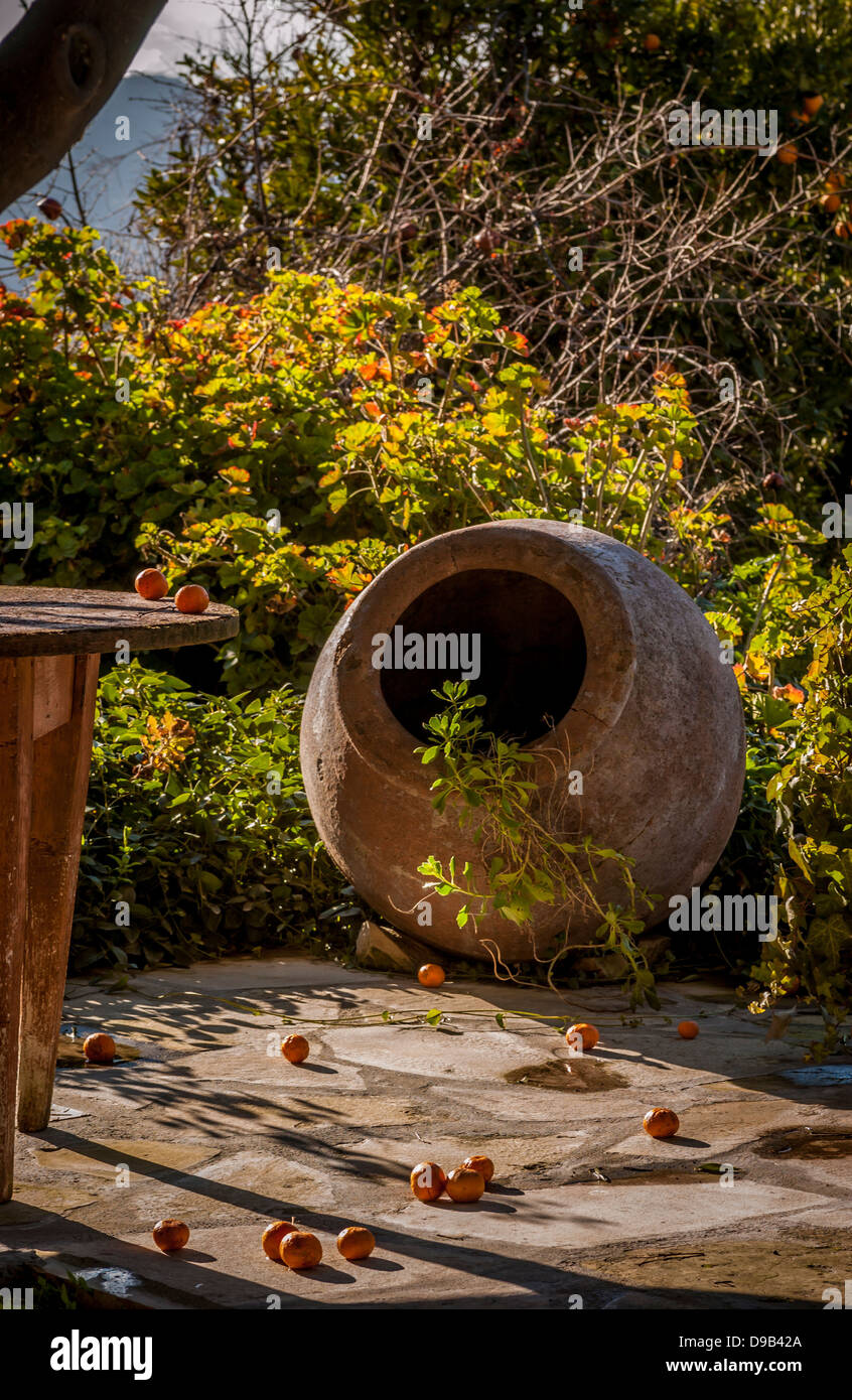 Amphora style clay pot laid on its side, in a Cypriot garden with ...