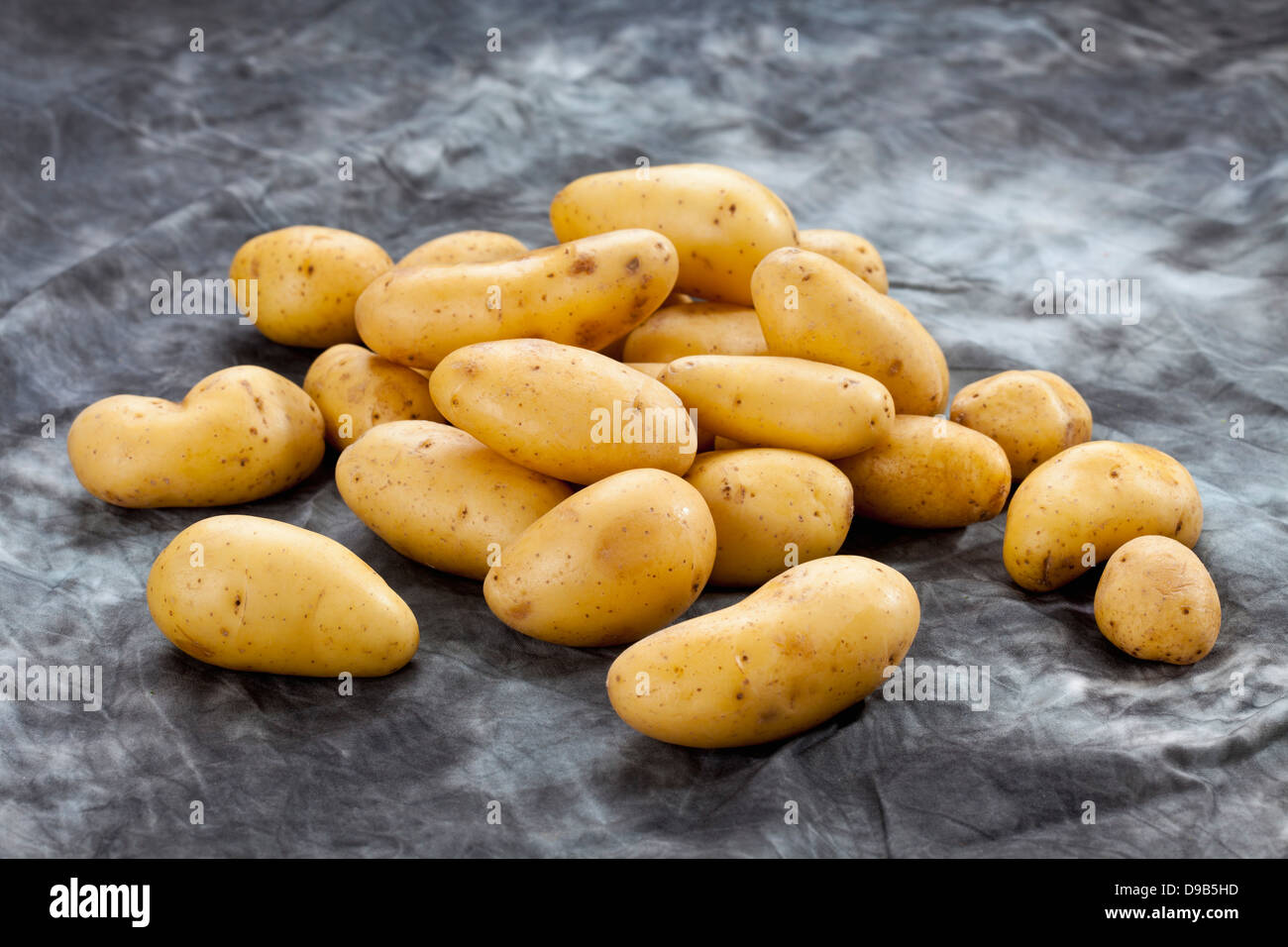 Potatoes on grey background, close up Stock Photo - Alamy