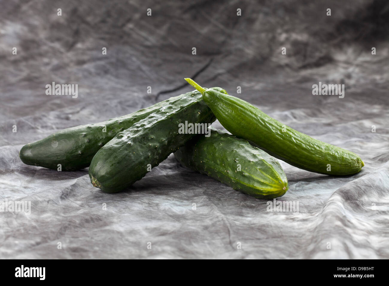 Stacked cucumber on grey background, close up Stock Photo - Alamy