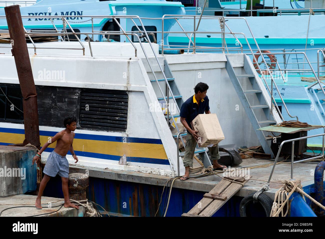 Men working on Boat on the River Pak Nam Krabi in Thailand Stock Photo ...