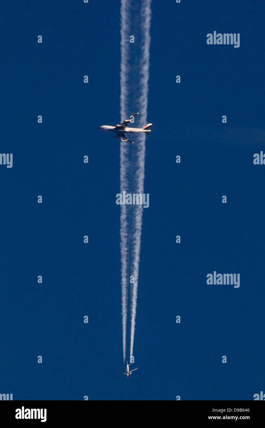 The flight paths of two passenger air planes seem to cross in the clear ...
