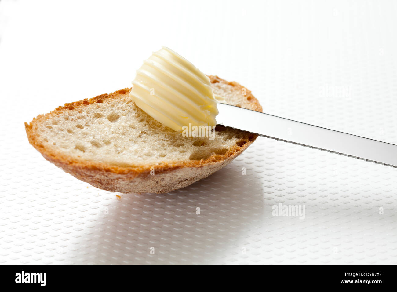 Edge of white bread with curl of butter, close up Stock Photo - Alamy