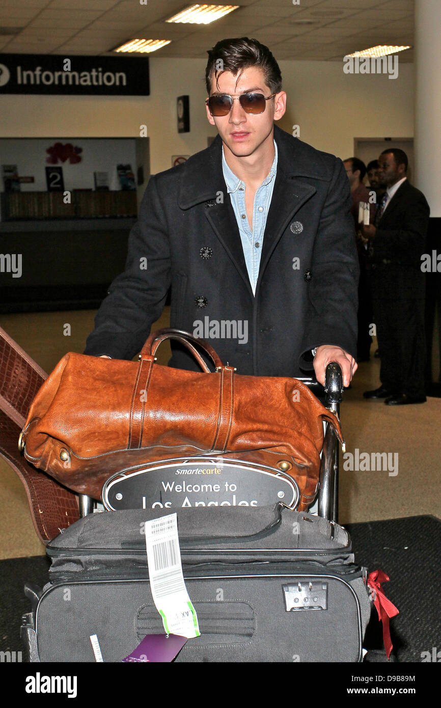 Arctic Monkeys frontman Alex Turner comes through the arrivals hall at ...