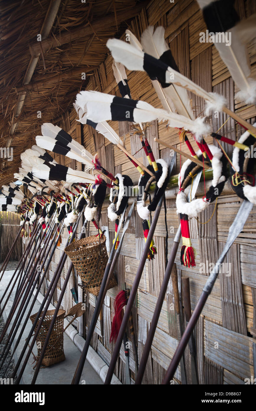 Traditional Naga tribal weapons and headdresses on wall during the ...