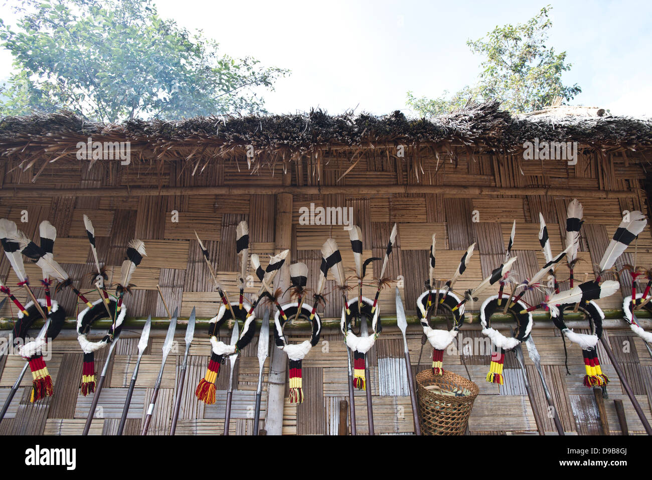 Traditional Naga tribal weapons and headdresses on wall during the ...