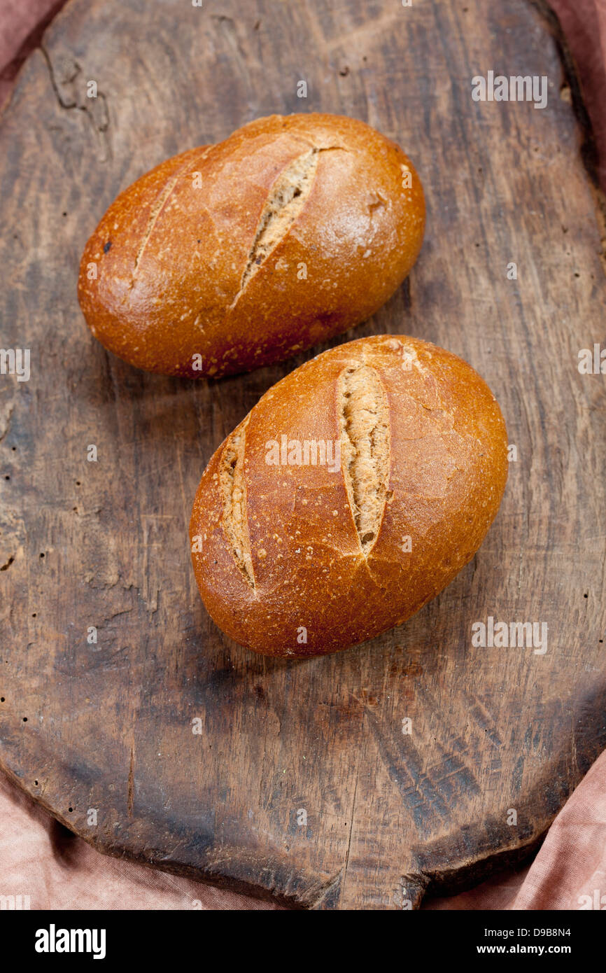 Rye rolls on chopping board, close up Stock Photo - Alamy