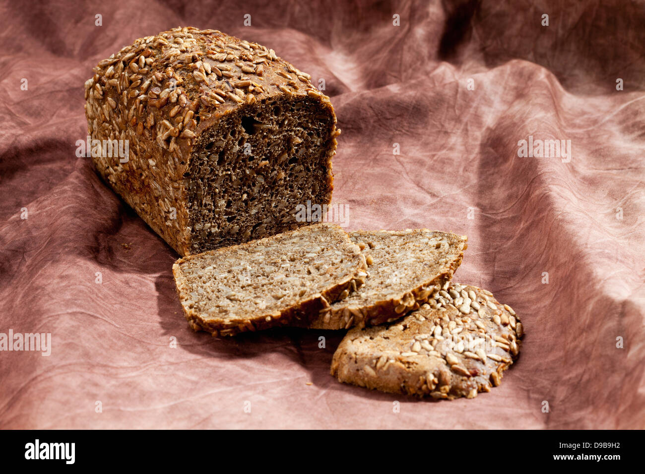 Slices of tin loaf with sunflower seeds on textile, close up Stock ...