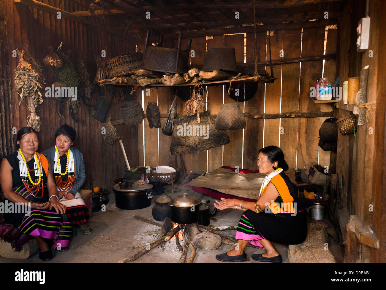 Naga tribeswomen cooking in hut hi-res stock photography and images - Alamy