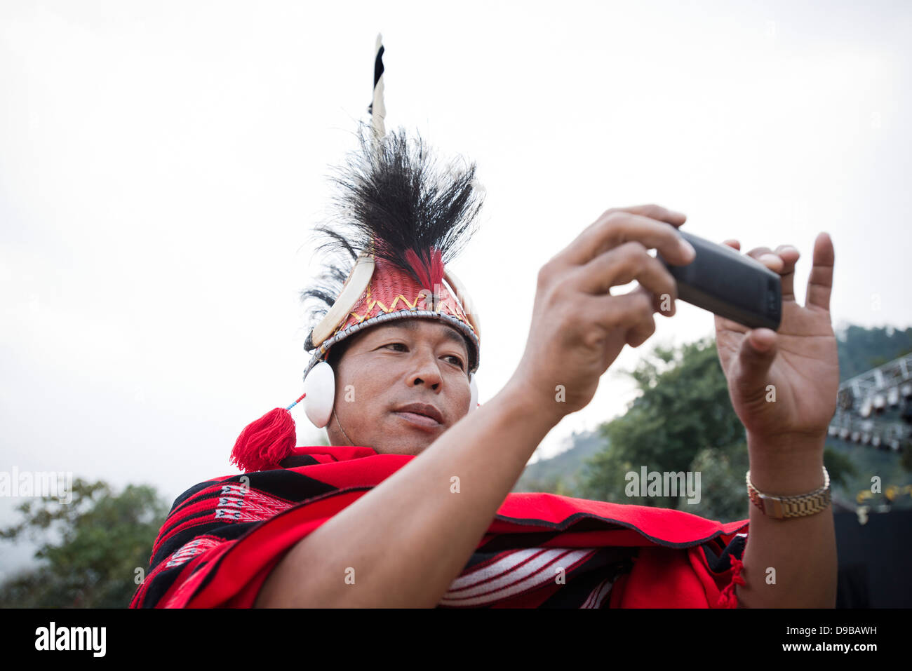 Naga tribesman photographing with a cell phone during the annual ...