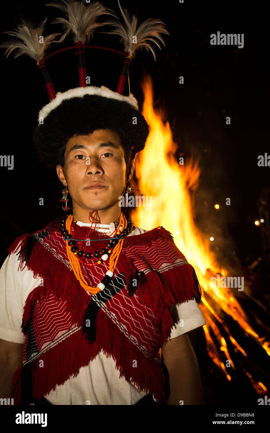 Naga tribesman in front of fire during the annual Hornbill Festival at ...