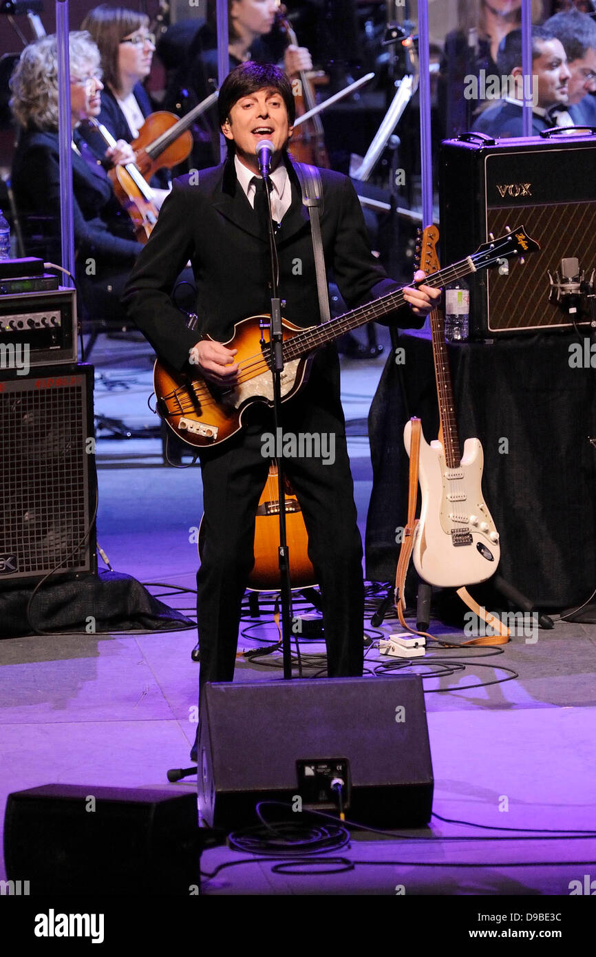 Tony Kishman, as Paul McCartney, performs on stage during the ...