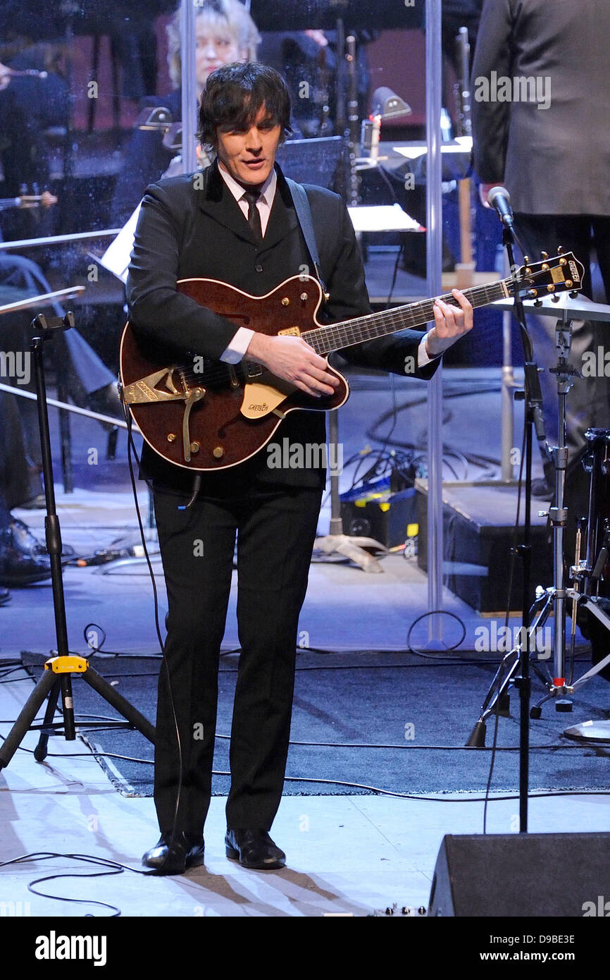 John Brosnan, as George Harrison, performs on stage during the ...