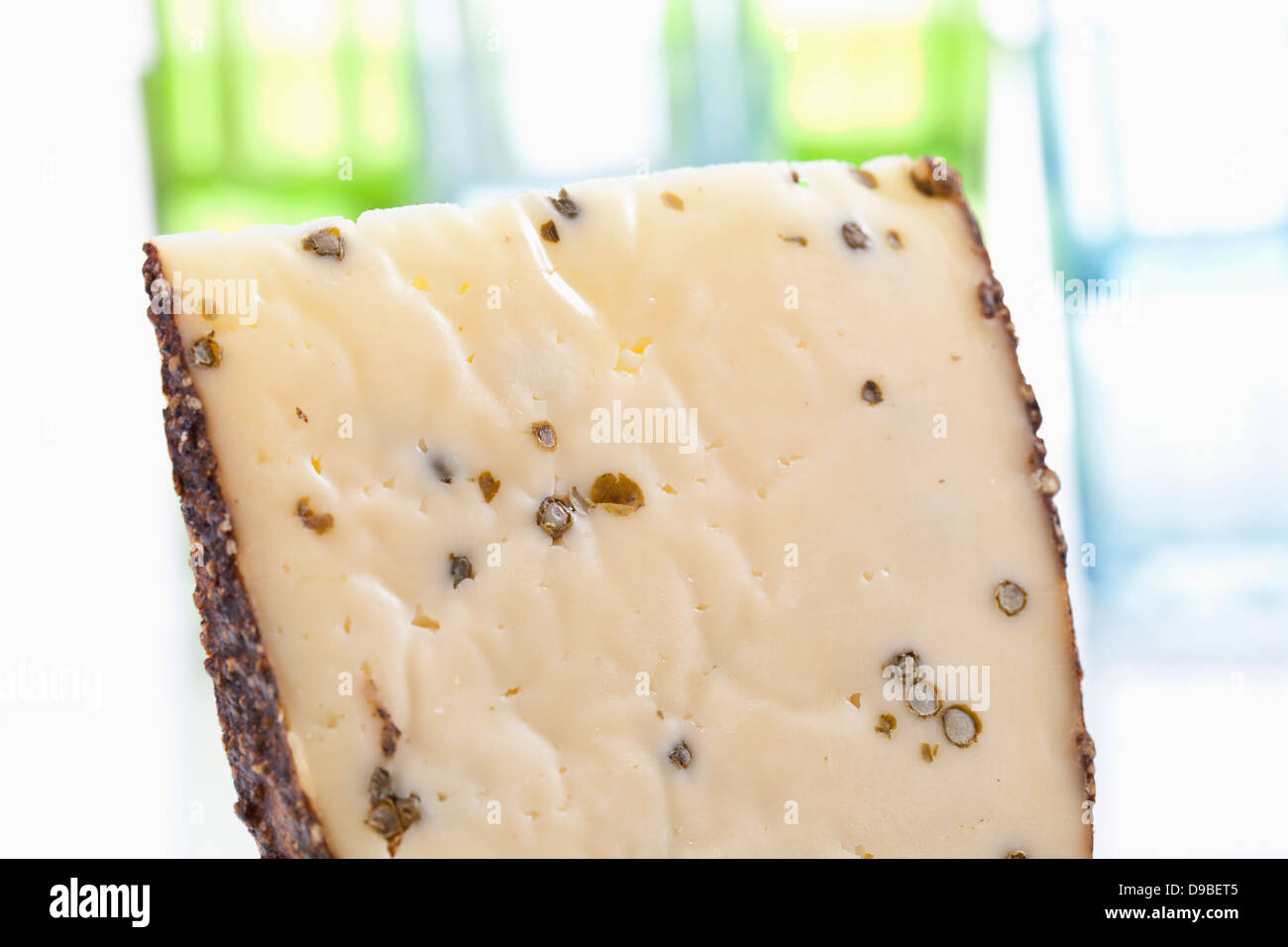 Slice of pepper cheese, close up Stock Photo - Alamy
