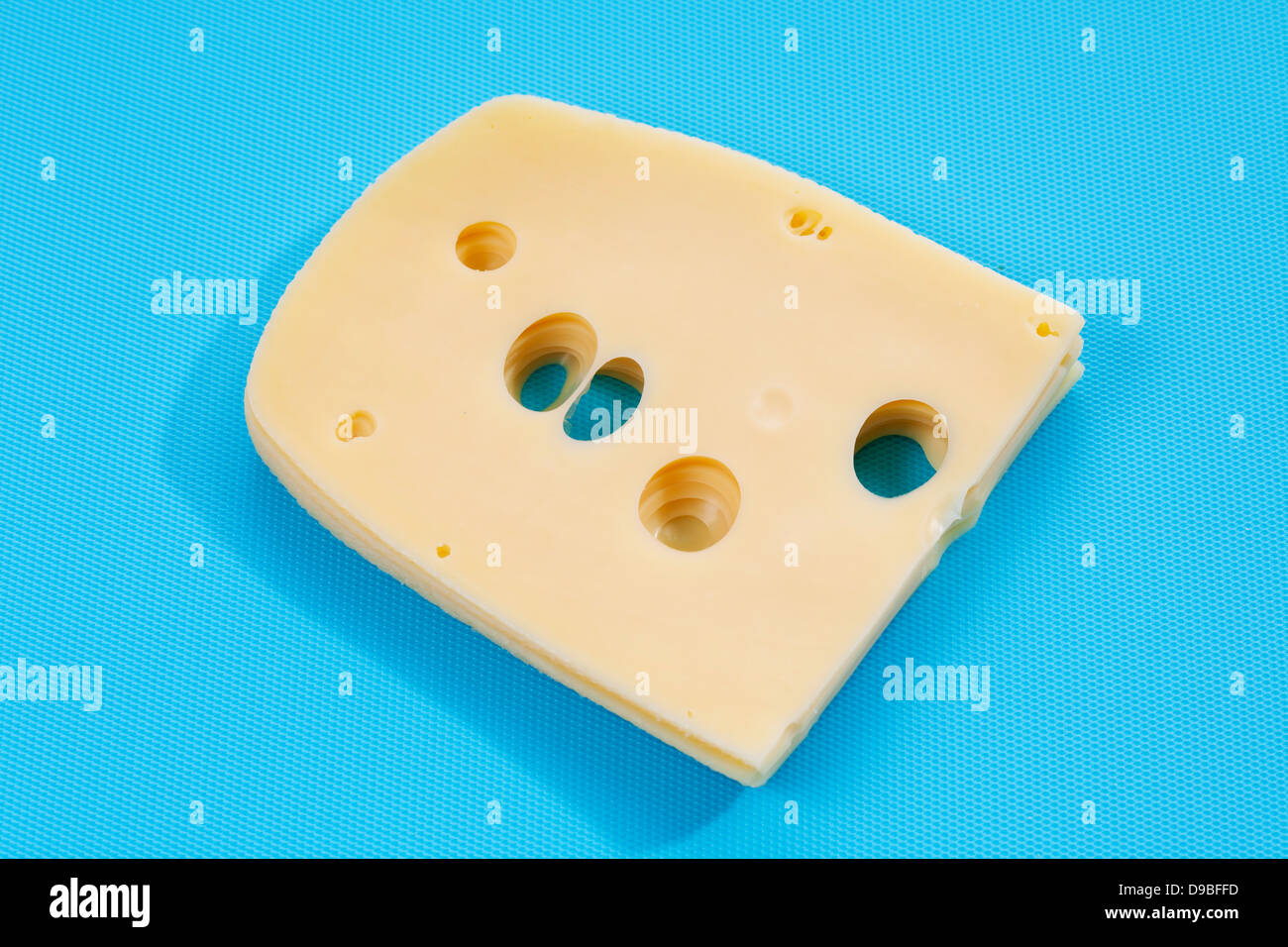 Slice of Leerdammer Cheese on blue background, close up Stock Photo - Alamy