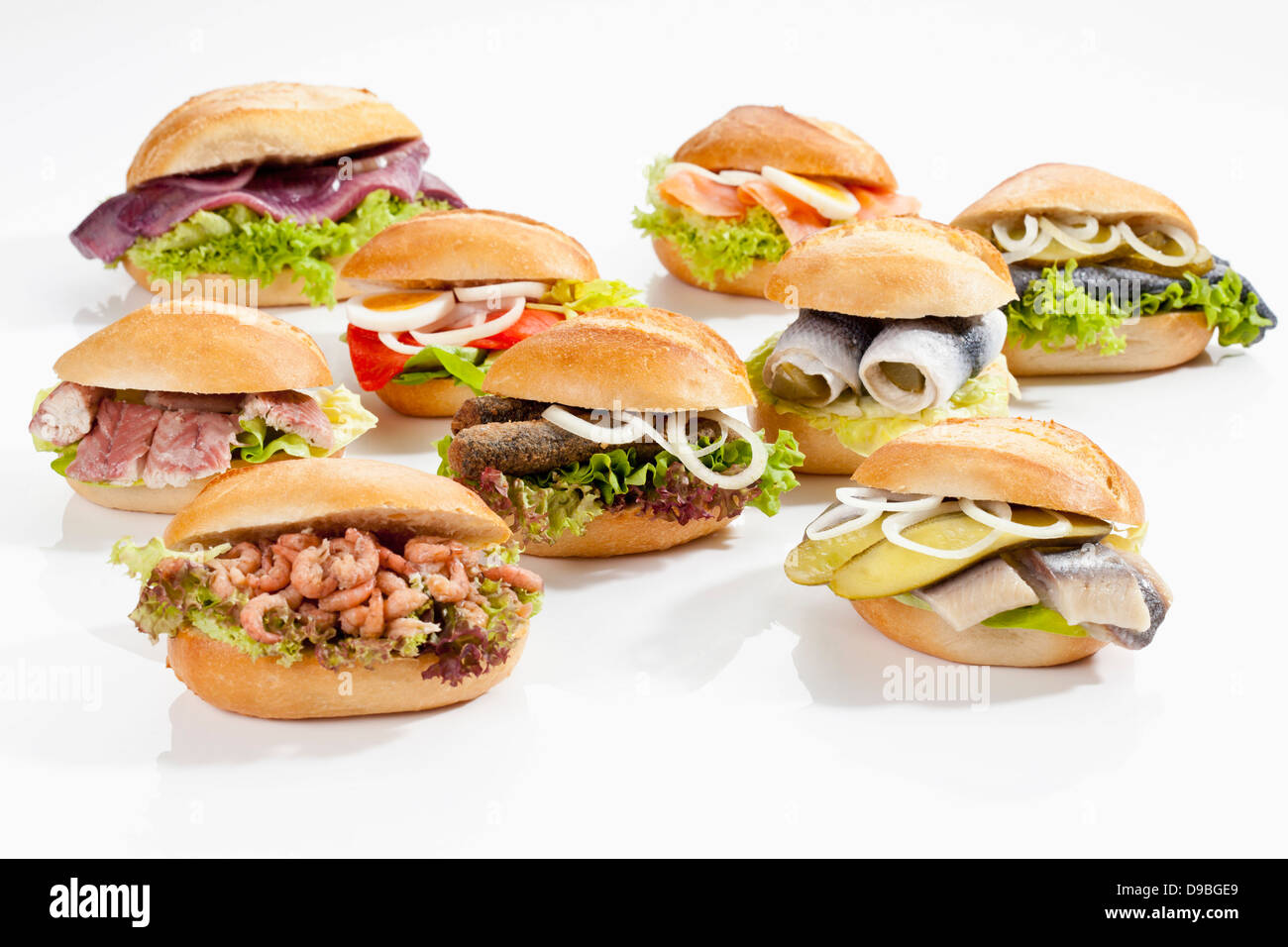 Varieties of bread rolls with fish on white background, close up Stock ...