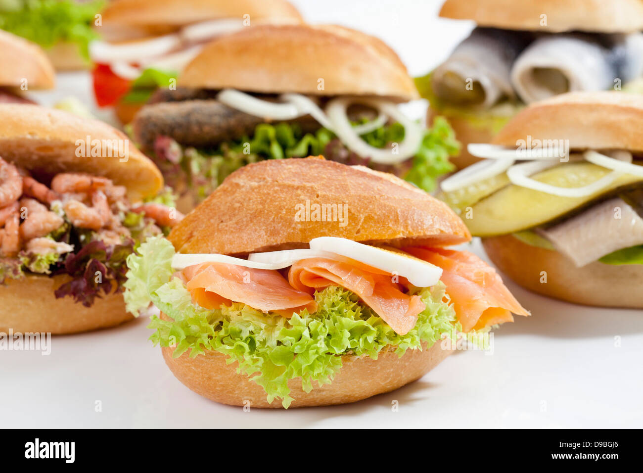 Varieties of bread rolls with fish on white background, close up Stock ...