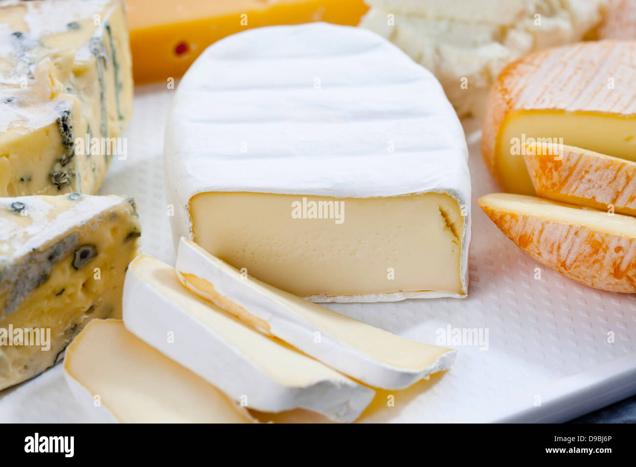 Varieties of cheeses on chopping board, close up Stock Photo - Alamy