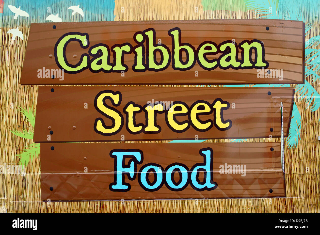 Caribbean street food sign at the Car Free Day festival on Main Street ...