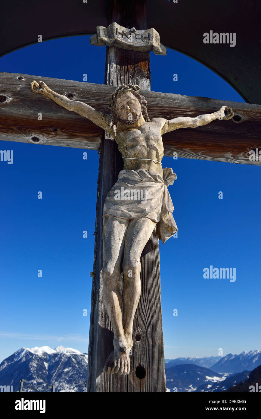 Germany, Bavaria, Carved wooden Jesus crucifix on Kreuzeck Mountain ...