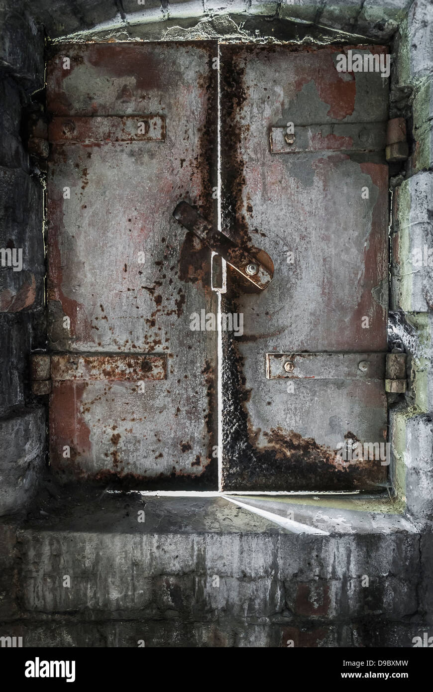 An old, rusting cast iron dungeon door letting in chinks of sunlight Stock Photo - Alamy