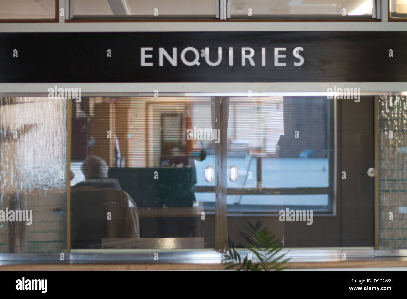 Old fashioned enquiries desk and glass hatch where members of the ...