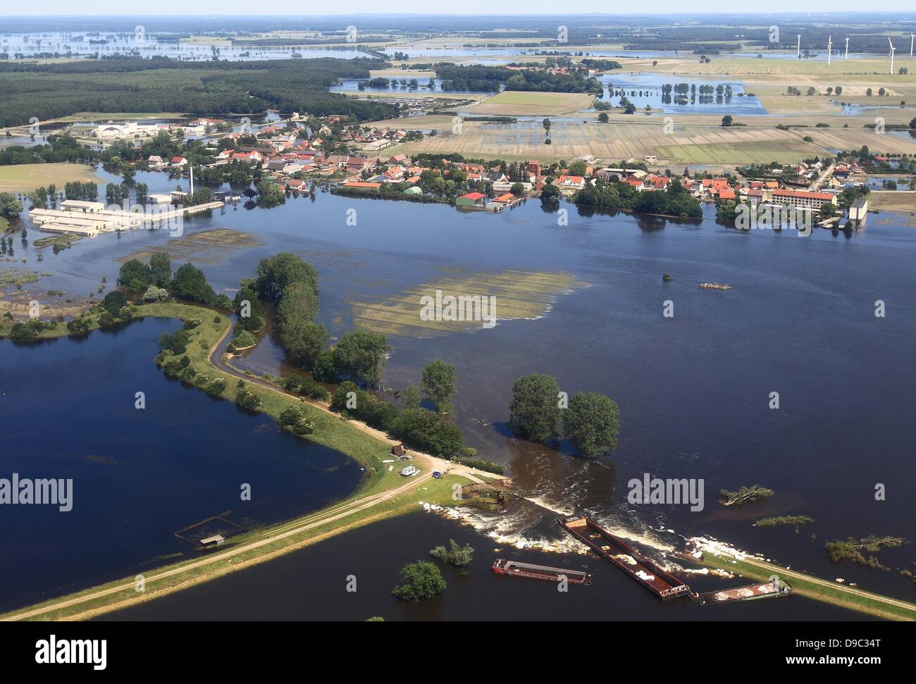 Deliberately placed river barges block the gap of a breached dam in ...