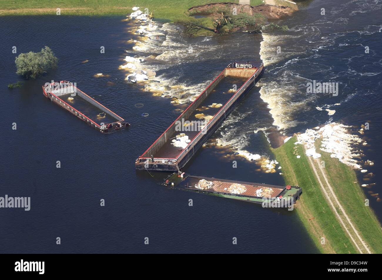 Deliberately placed river barges block the gap of a breached dam in ...