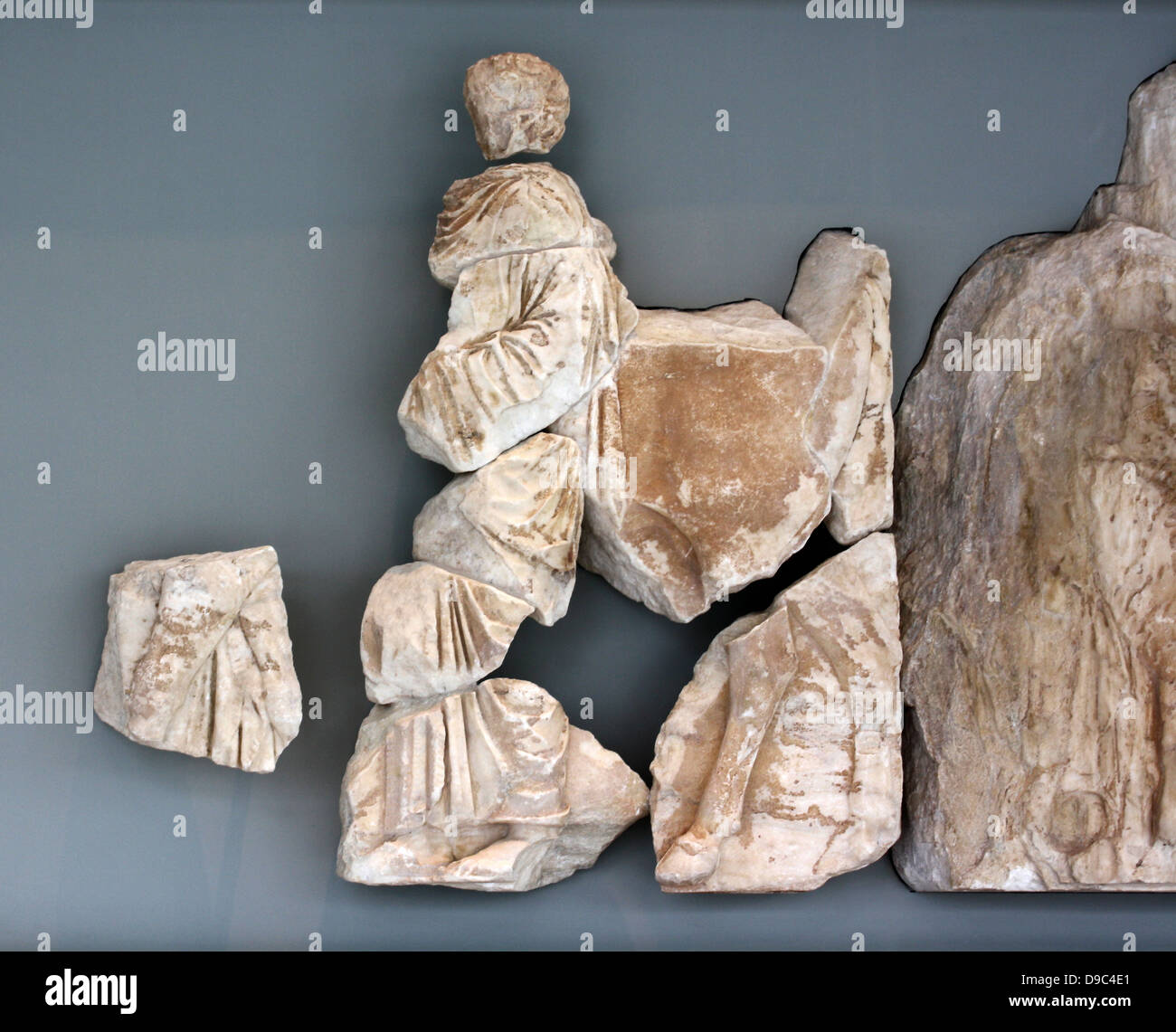 Three men wrapped tightly in their himatia lead two sacrificial bulls ...