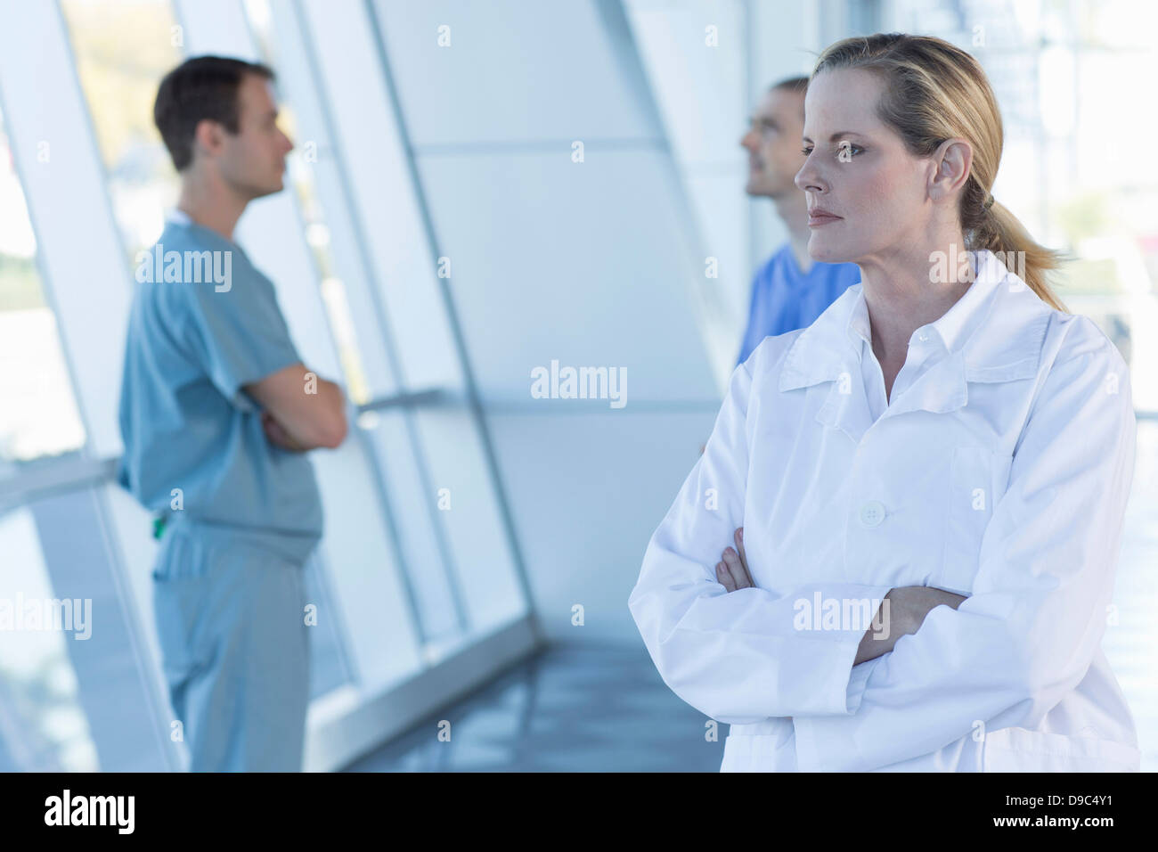 Female doctor with arms folded Stock Photo - Alamy
