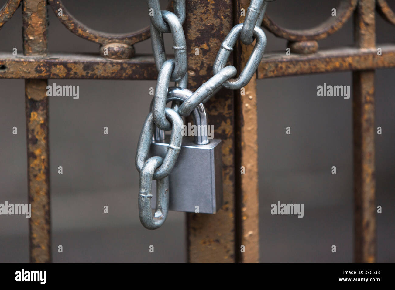 New padlock on old metal gate Stock Photo - Alamy