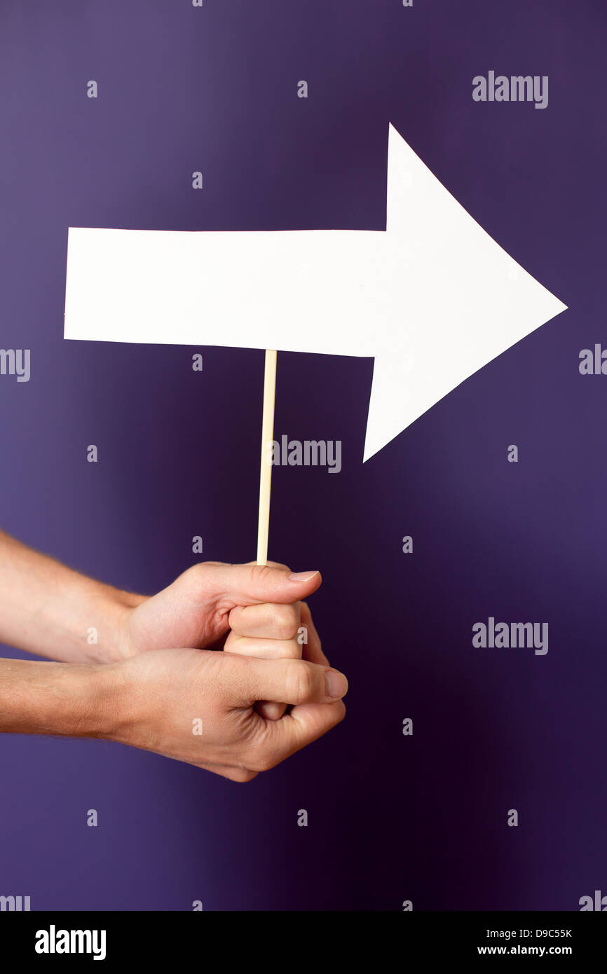 Hand holding an arrow Stock Photo - Alamy