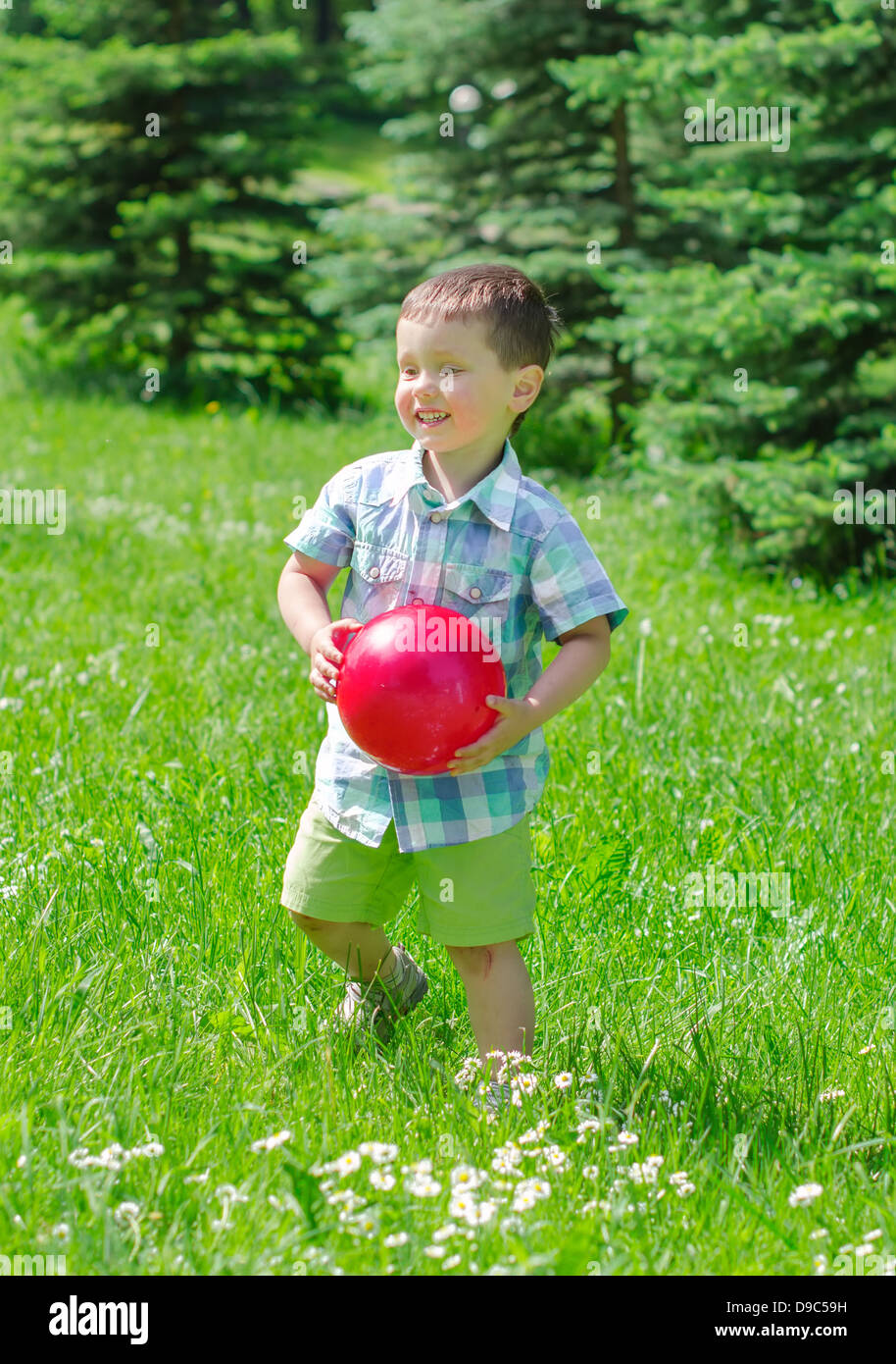 Little boy playing with ball in the park Stock Photo - Alamy