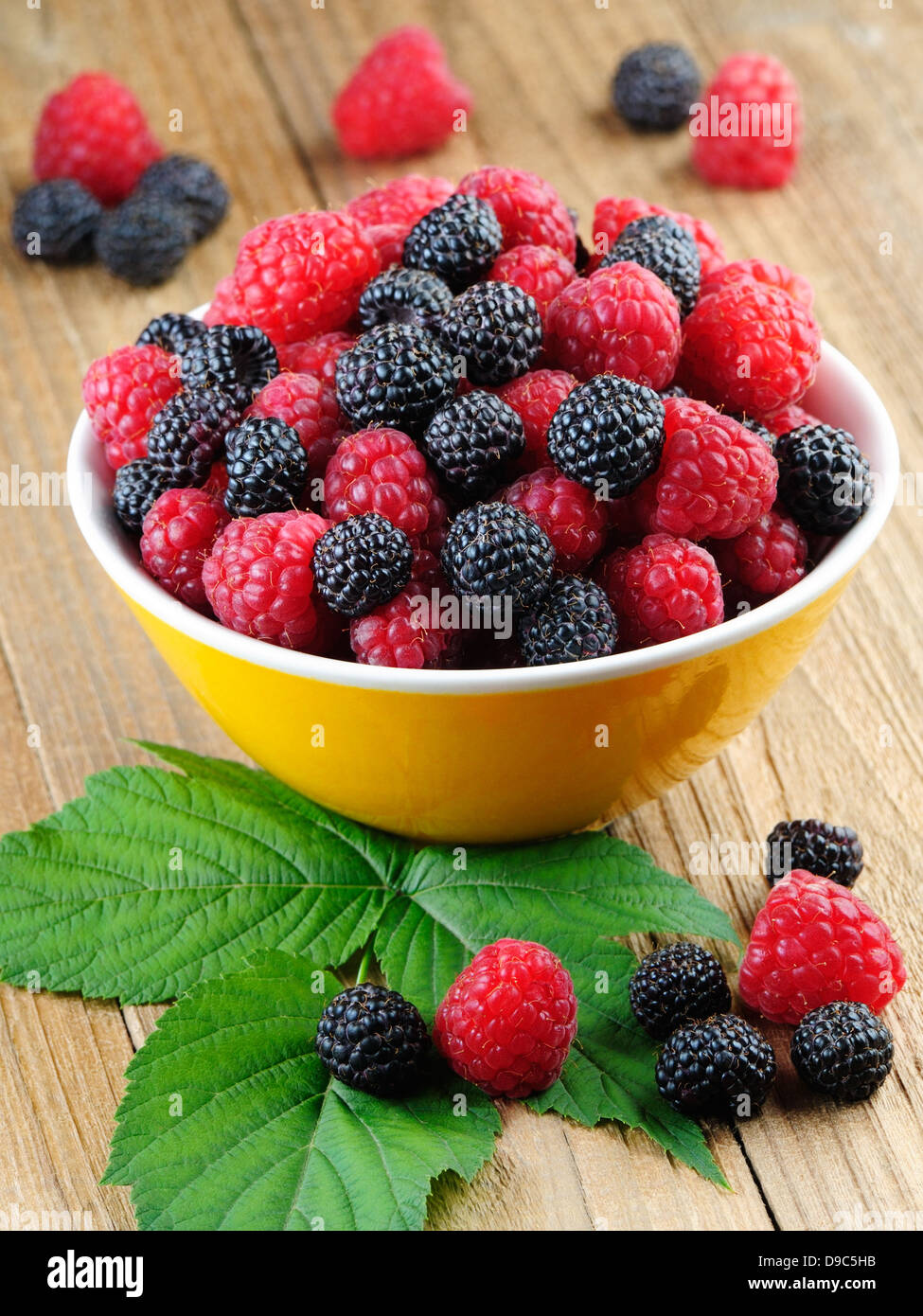 Raspberry in bowl on wooden background Stock Photo - Alamy