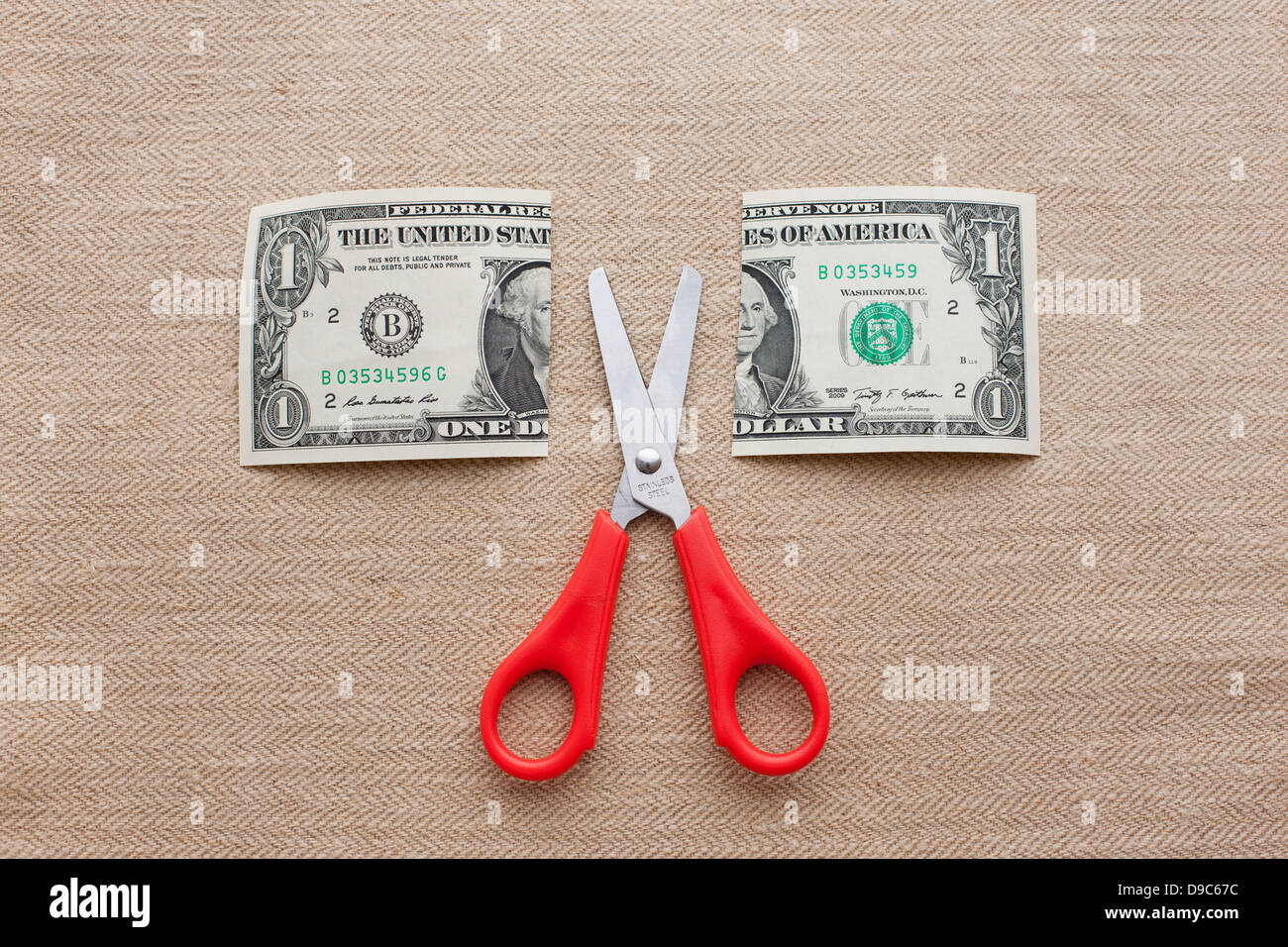 One dollar bill cut in half with scissors Stock Photo - Alamy
