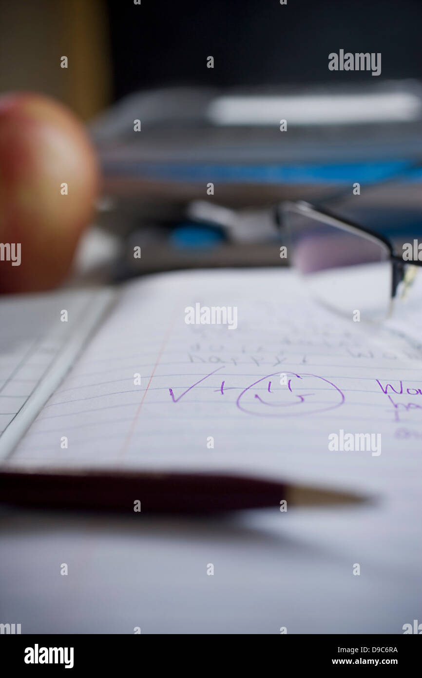 Marked school notebook with smiley face Stock Photo - Alamy