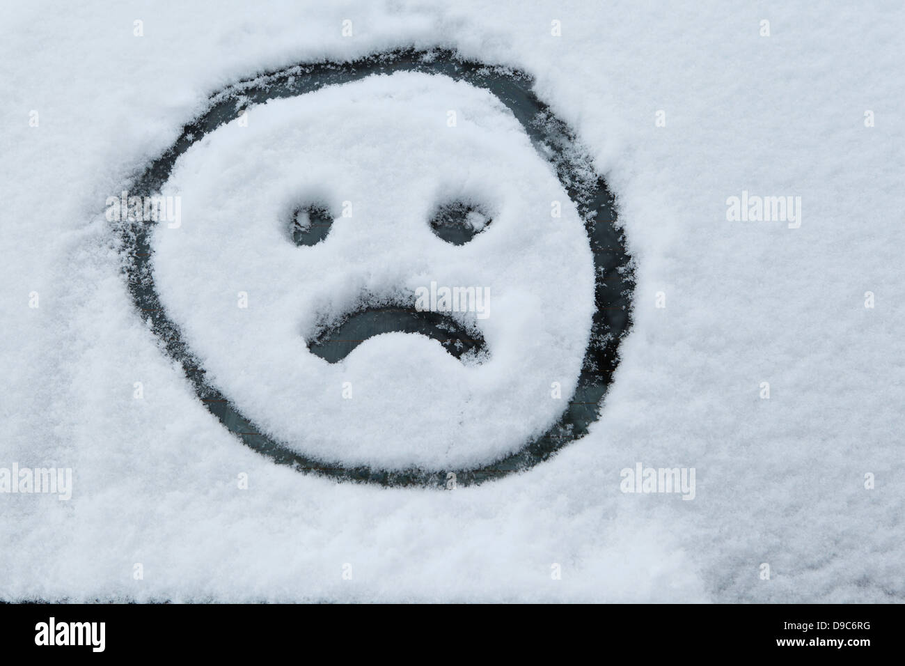 Sad face drawn in snow Stock Photo: 57431796 - Alamy