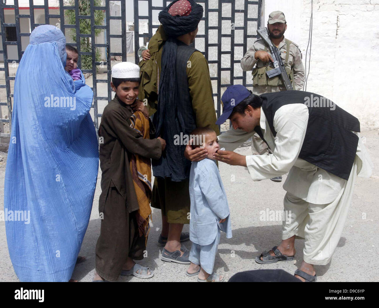 Health worker administrates polio-vaccine drops to a child during anti ...