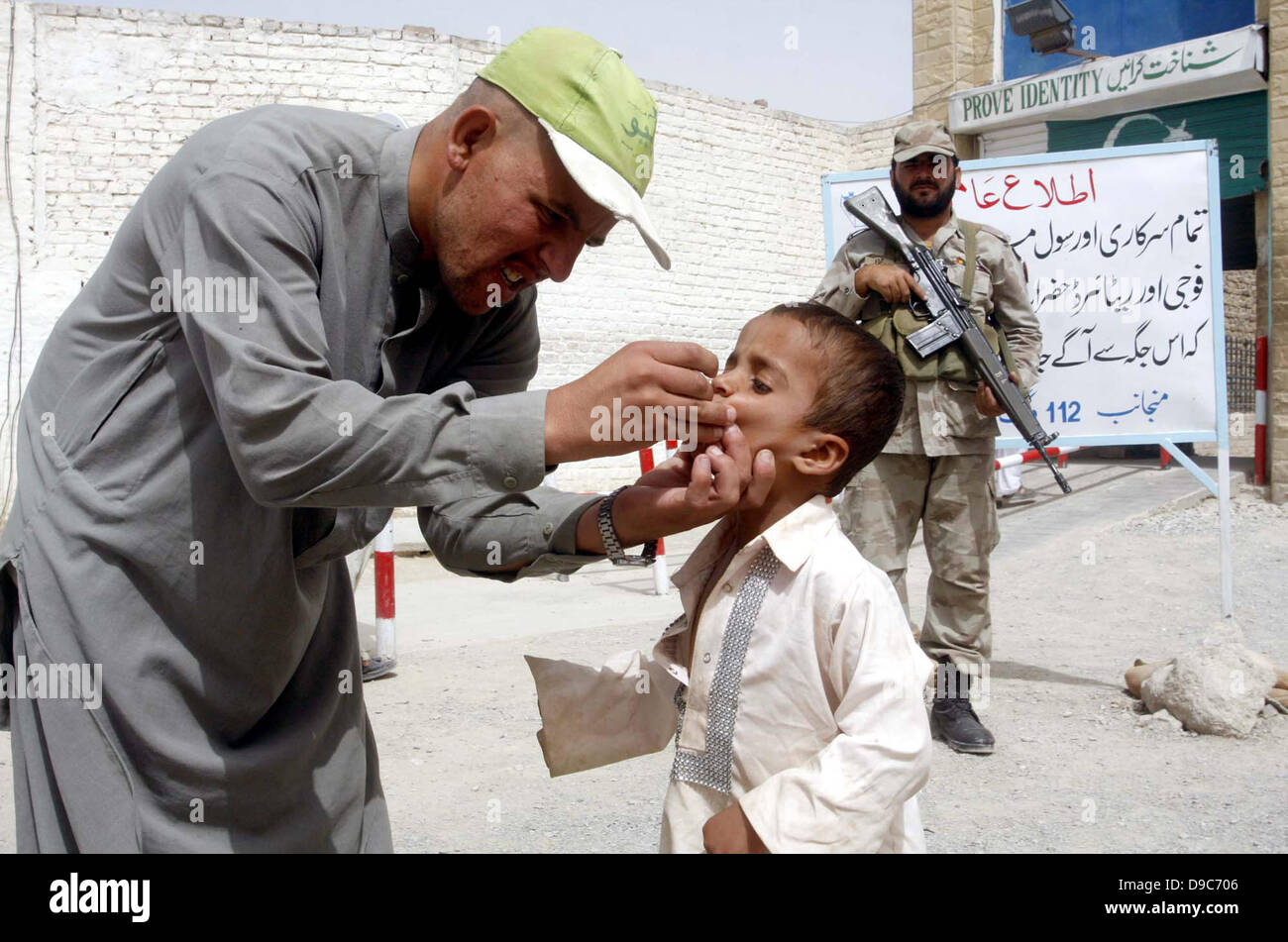 Health worker administrates polio-vaccine drops to a child during anti ...