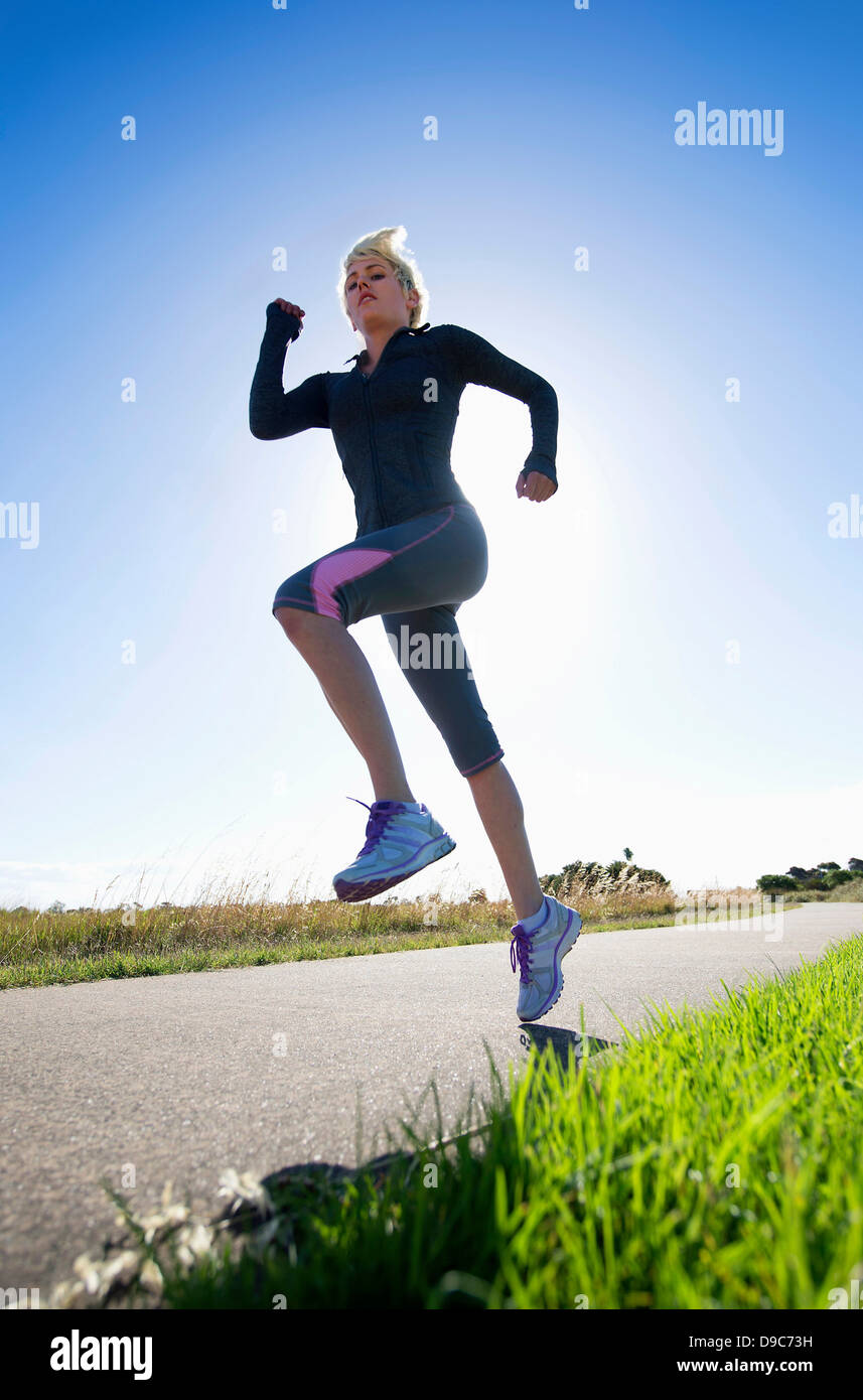 Young woman jogging, low angle Stock Photo - Alamy