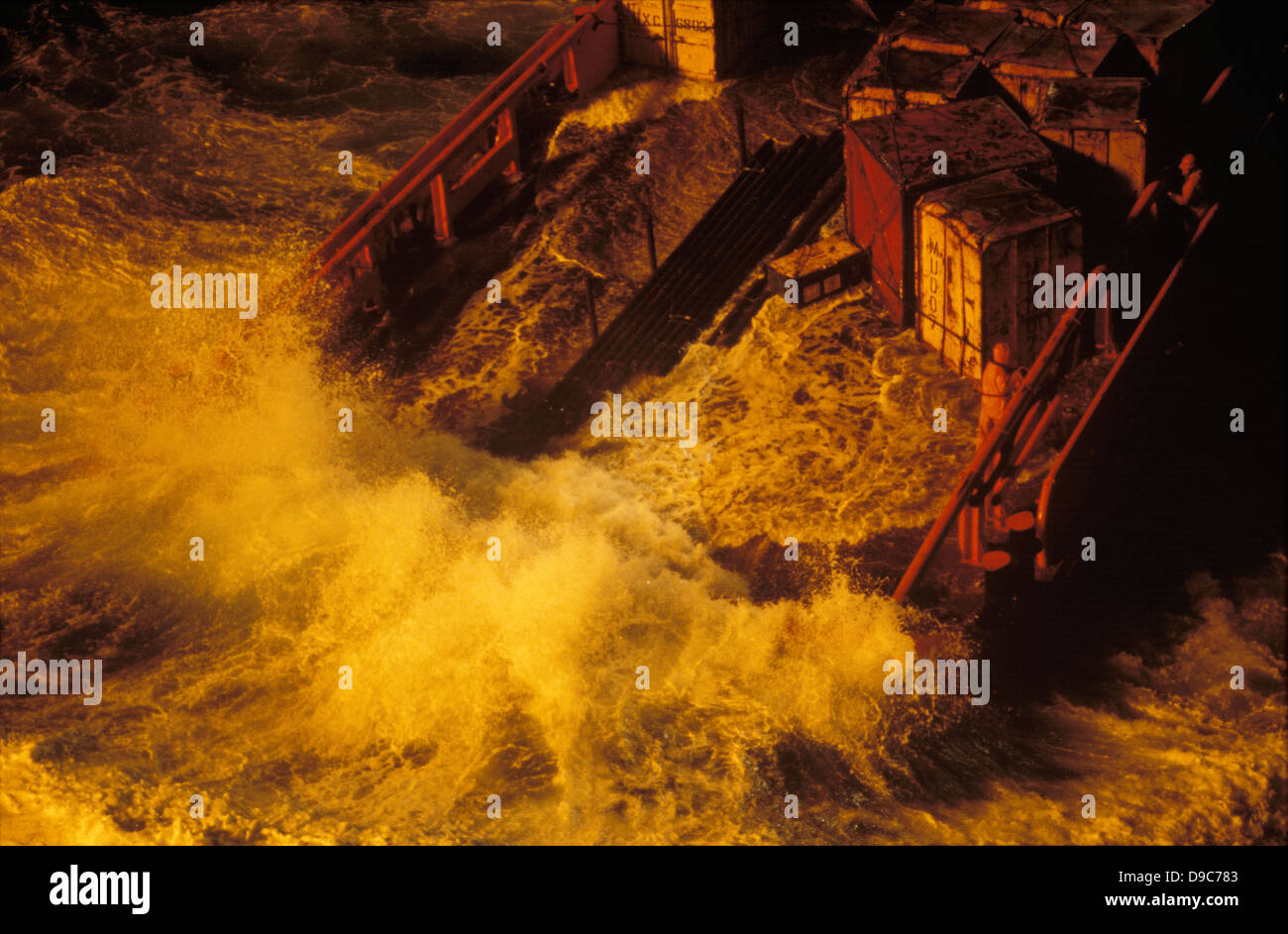 Supply Boat lit by flarestack at night, Rough Weather Stock Photo - Alamy