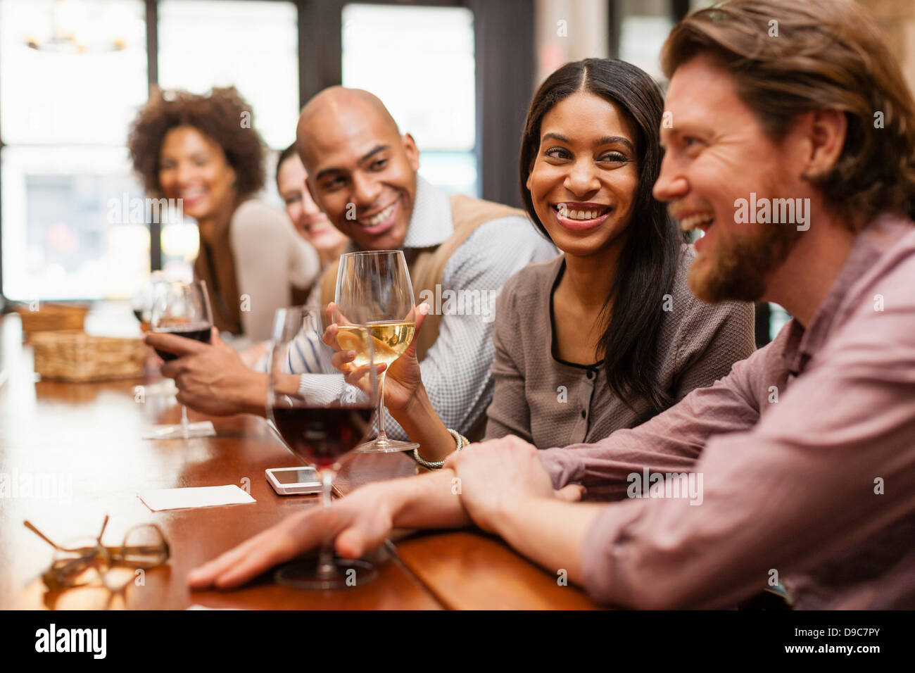 Friends chatting and laughing at bar Stock Photo - Alamy