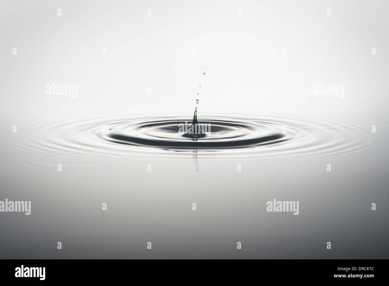 Water droplet falling into water Stock Photo - Alamy