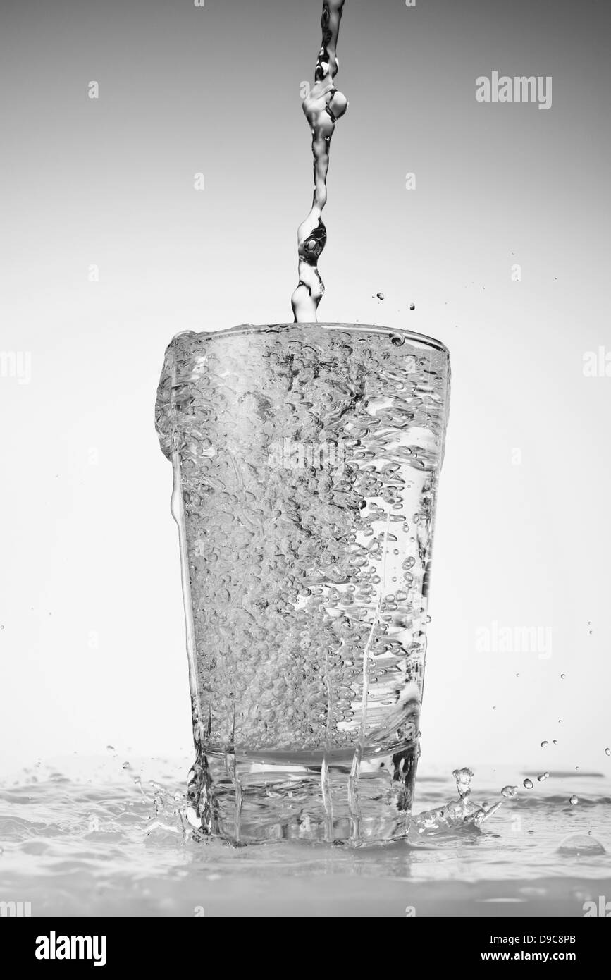 Pouring water into glass Black and White Stock Photos & Images - Alamy