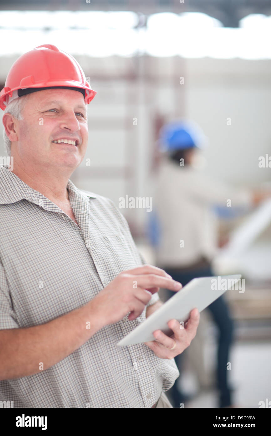 Male construction worker holding a digital tablet Stock Photo - Alamy