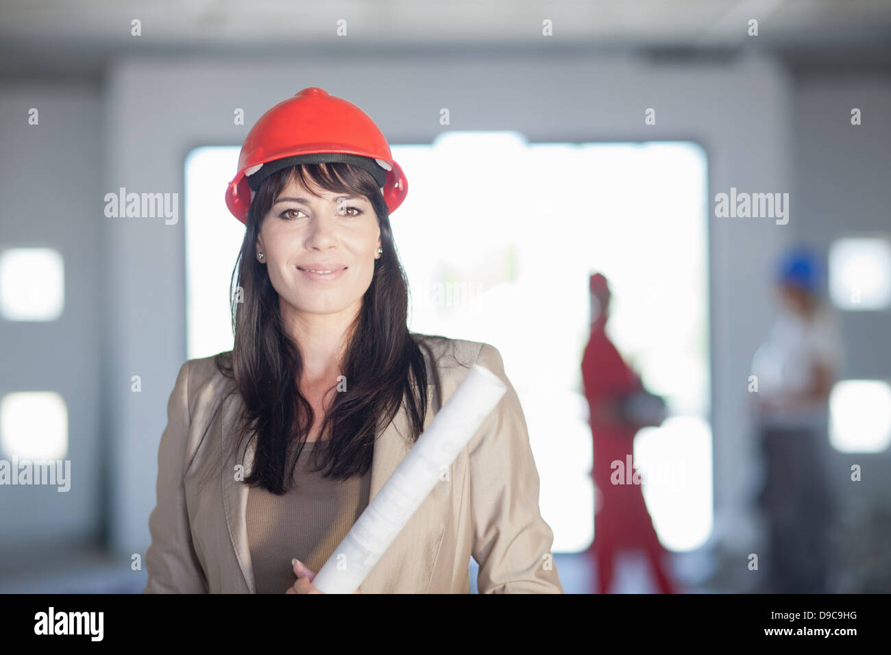 Female architect with blueprint Stock Photo - Alamy