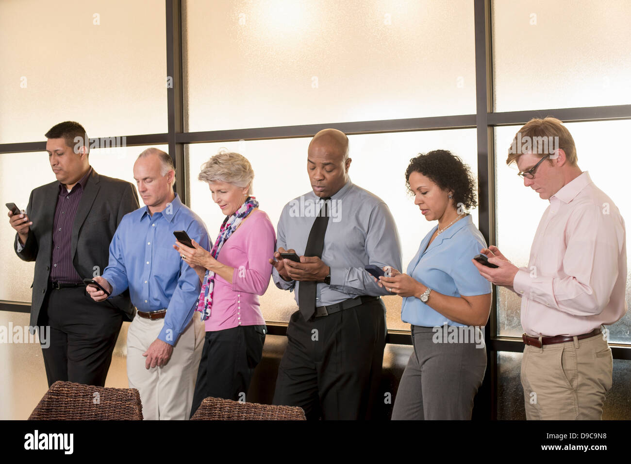 Business colleagues using cell phones Stock Photo - Alamy